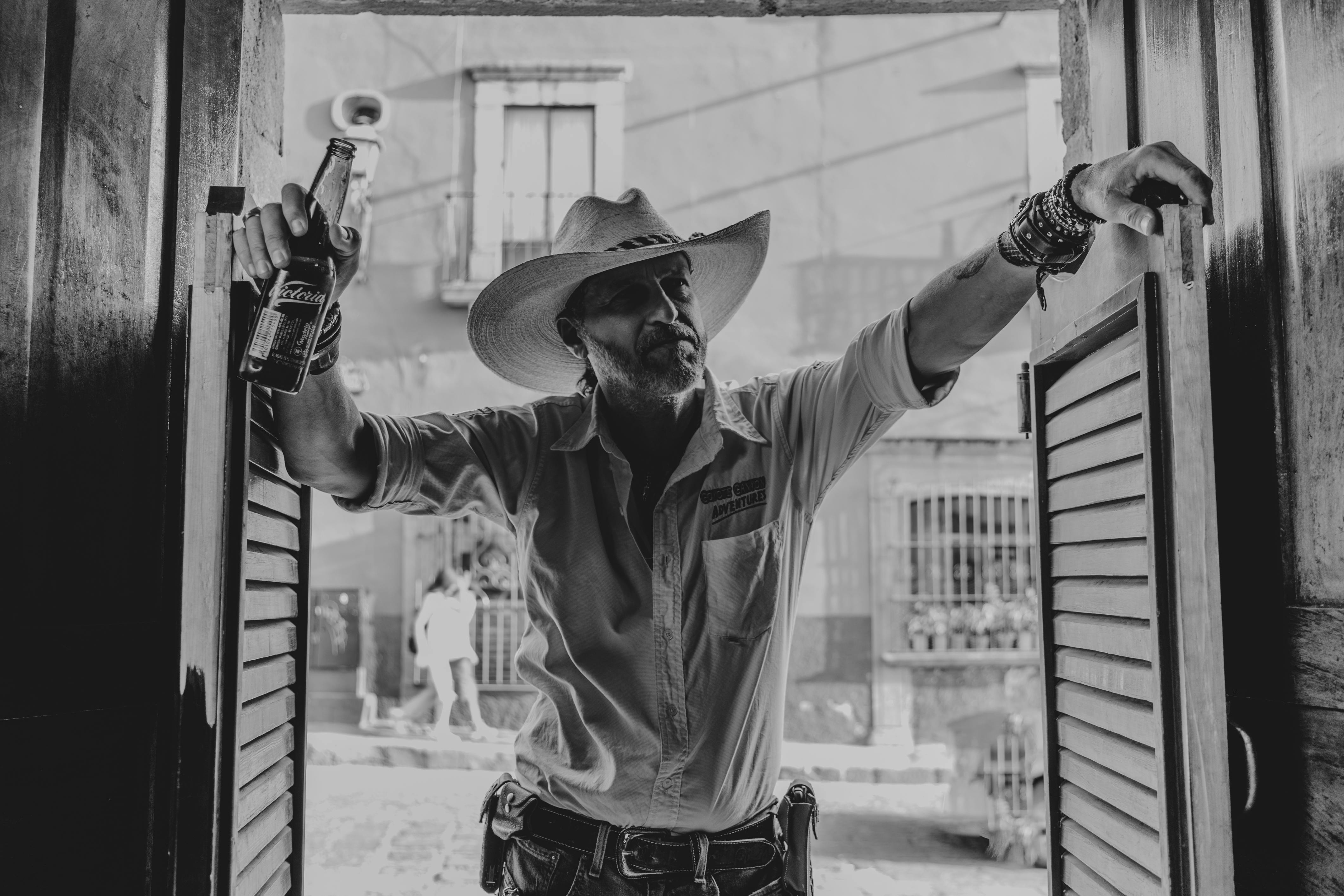 Cowboy celebrating with bottle in hand - bringing authentic saloon ...